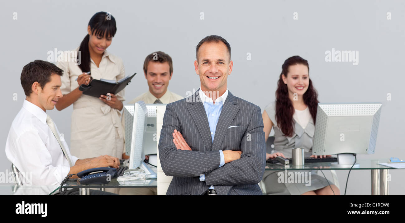 Concentrated Business partners working with their manager Stock Photo ...