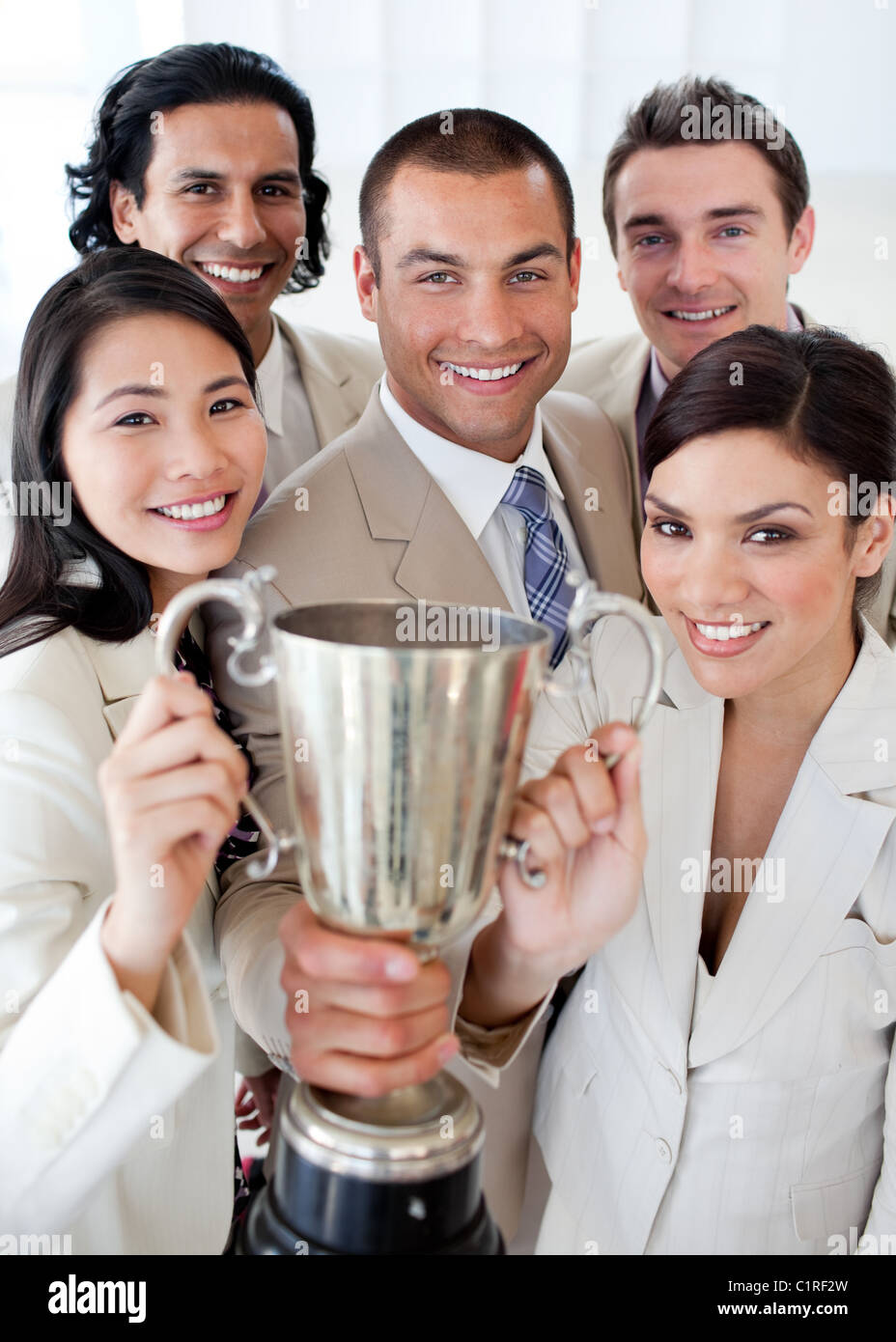 A successful business team holding a trophy Stock Photo - Alamy