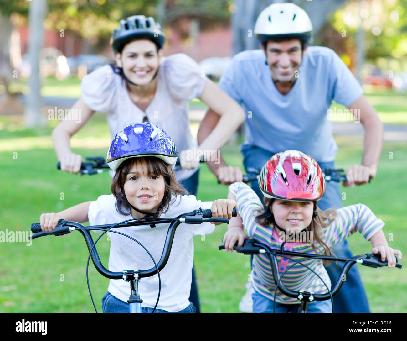 Happy family riding a bike Stock Photo - Alamy