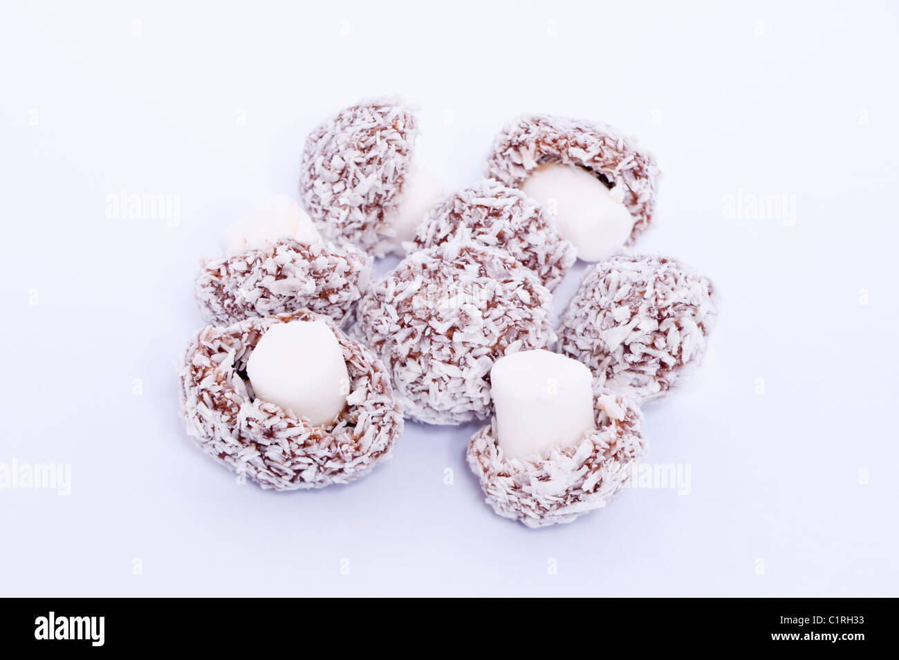 A selection of coconut mushrooms traditional sweets on a white ...