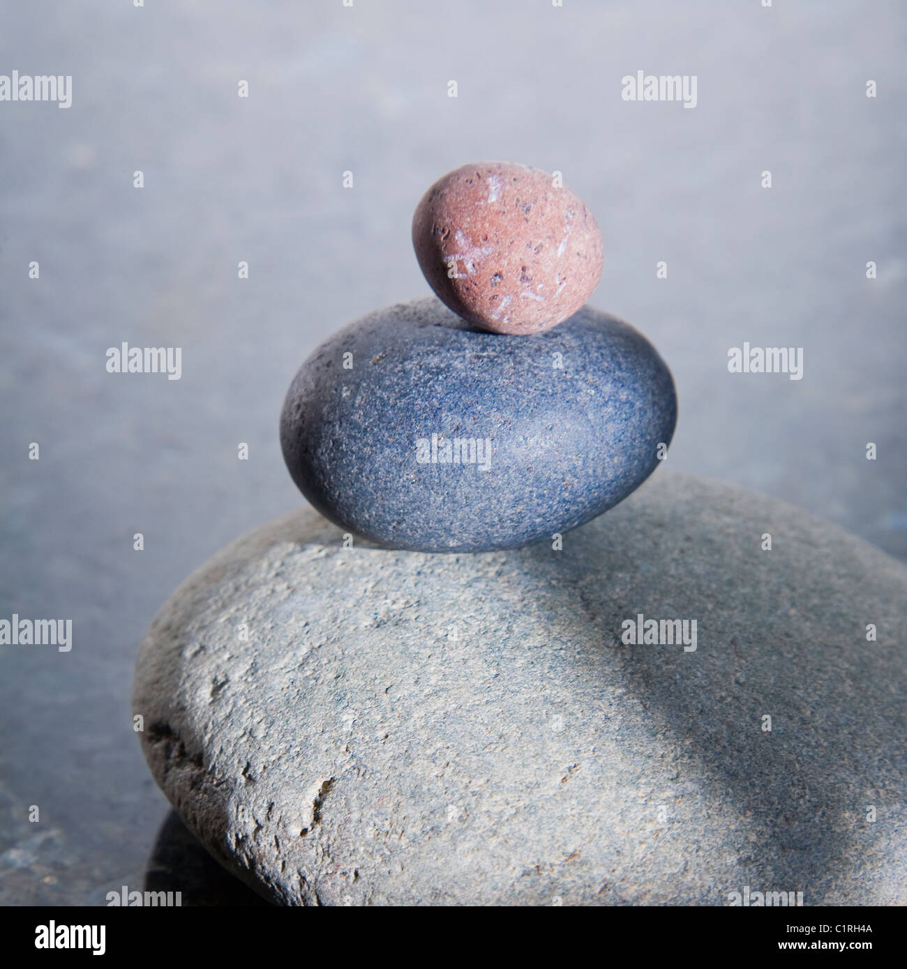 Stack of zen pebbles on a shiiny surface Stock Photo - Alamy