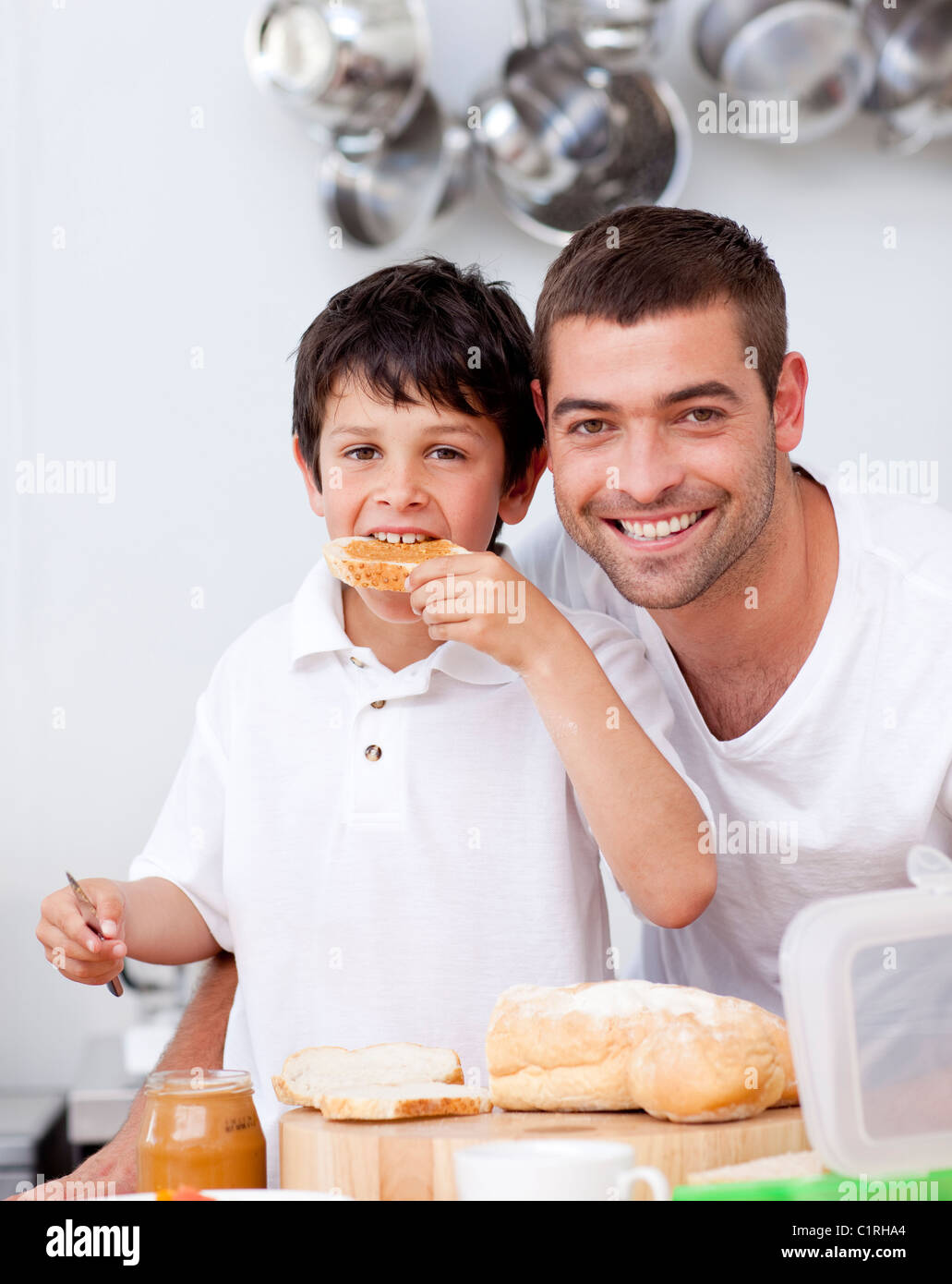 Father and son eating a toast Stock Photo - Alamy