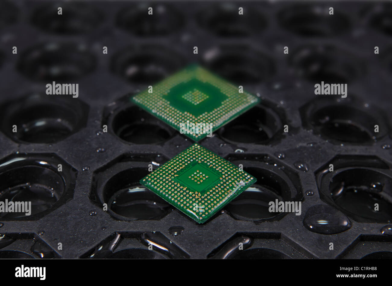 two computer processors on black rubber industrial mat Stock Photo - Alamy