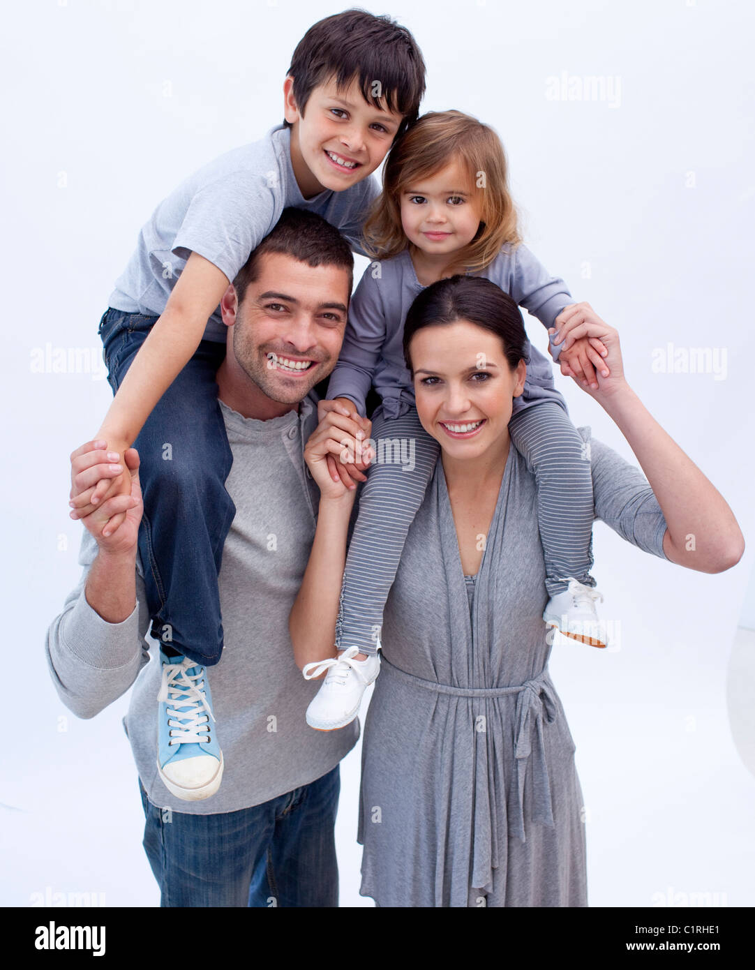 Couple giving piggyback ride children hi-res stock photography and ...