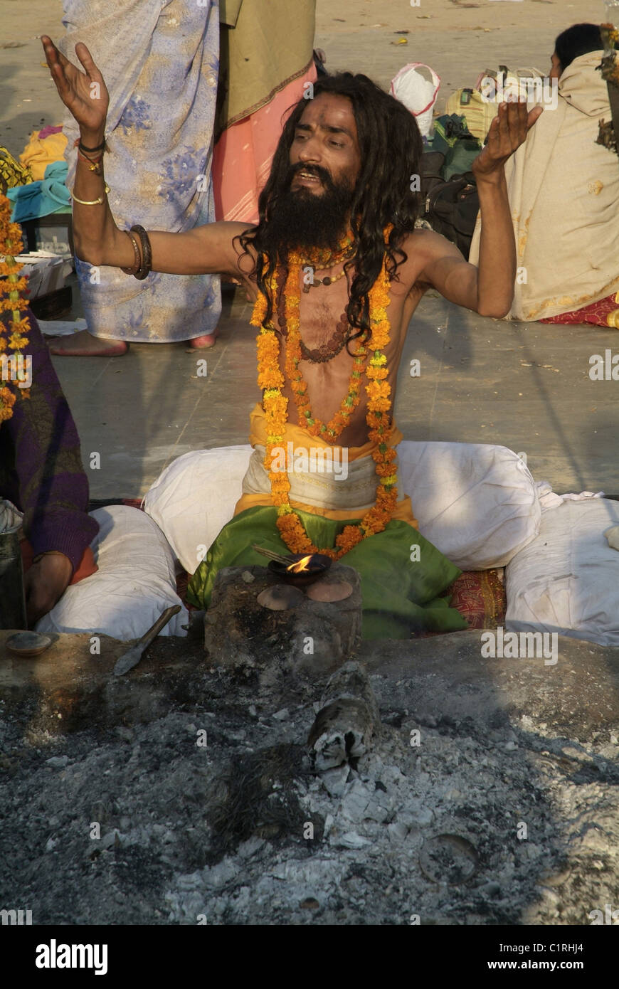 A Hindu Sadhu praying at a Ghat on the banks of the holy Ganges River ...