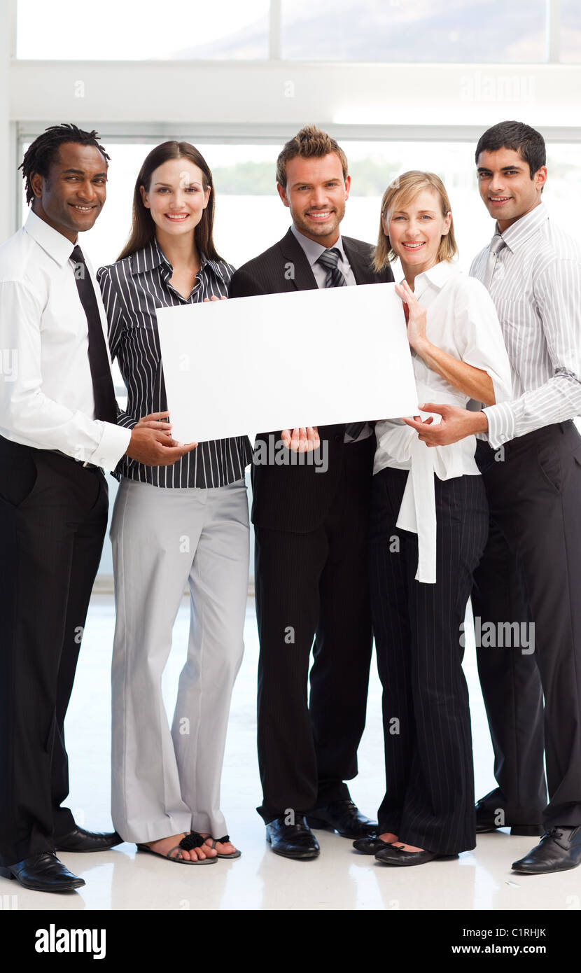 Business people showing a big white card Stock Photo - Alamy