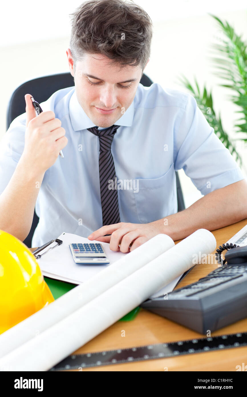 Concentrated male architect studying a project Stock Photo - Alamy