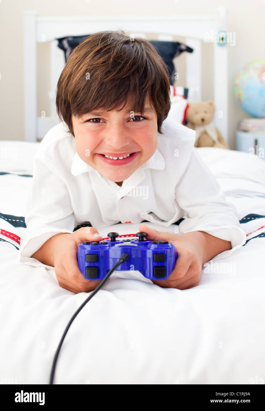 Happy boy playing video games Stock Photo - Alamy