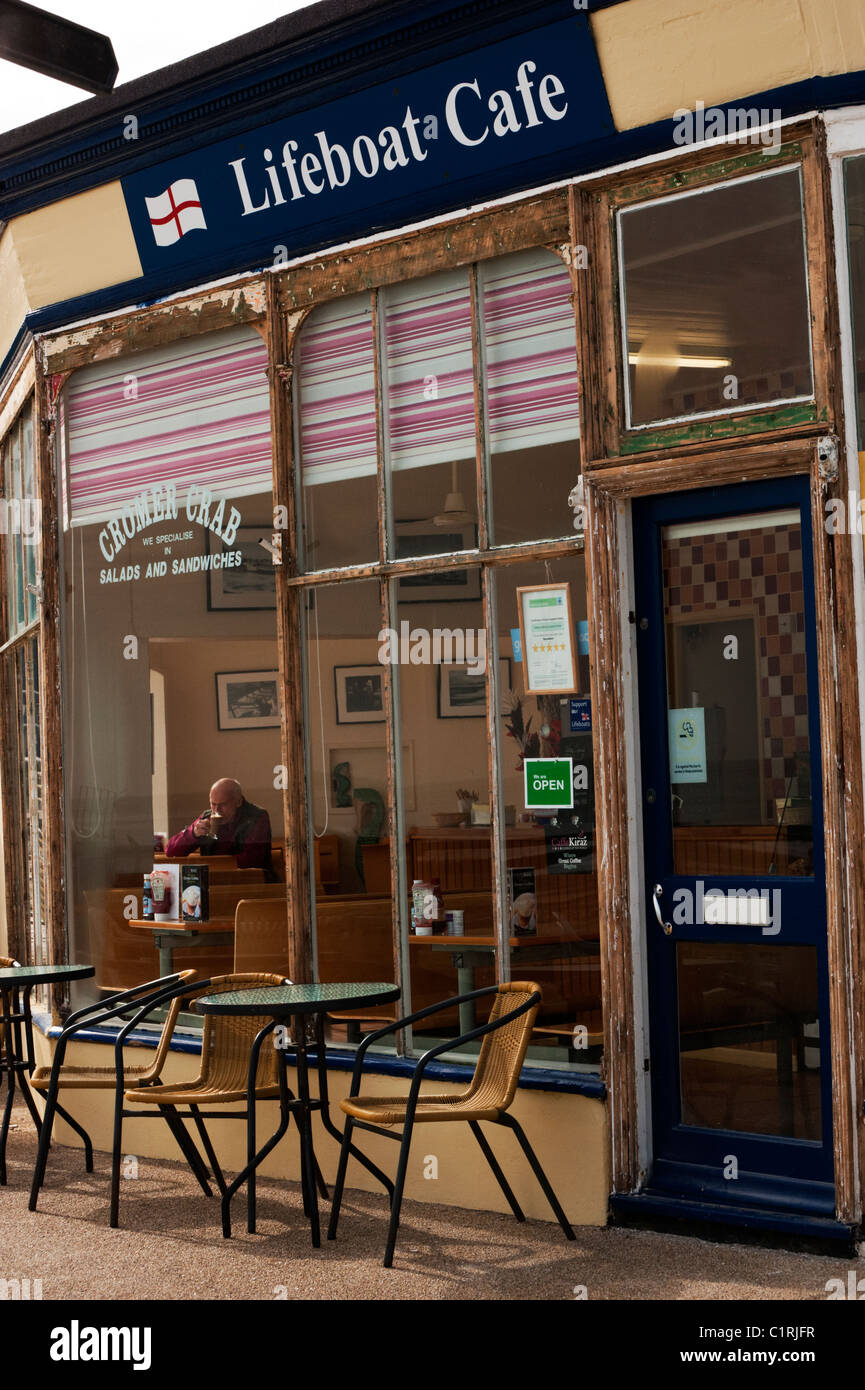 A man drinks coffee in the Lifeboat Cafe, Cromer, during the off season ...