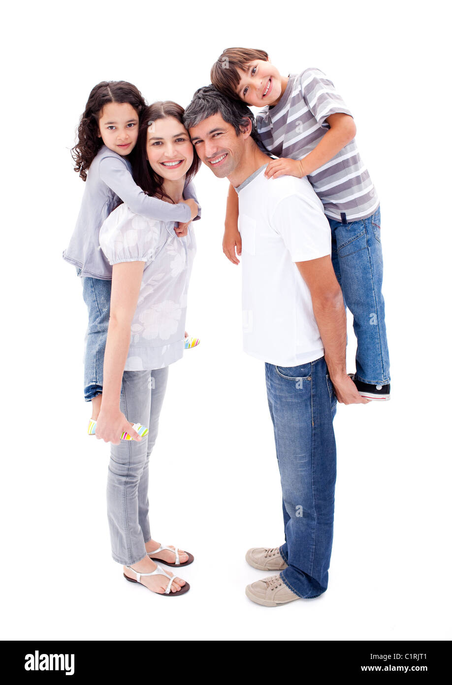 Affectionate parents giving their children a piggyback ride Stock Photo ...