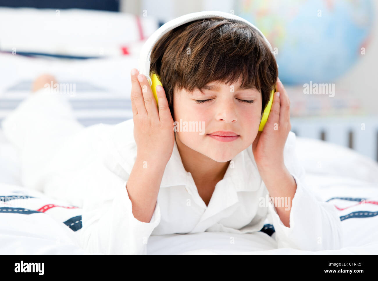 Cute boy listenning music Stock Photo - Alamy