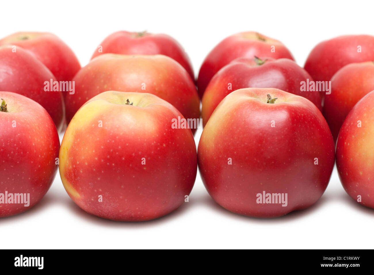 Red apple put in rows on white background Stock Photo - Alamy
