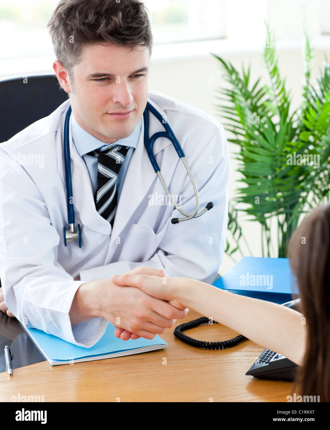 Confident doctor with his upset patient Stock Photo - Alamy