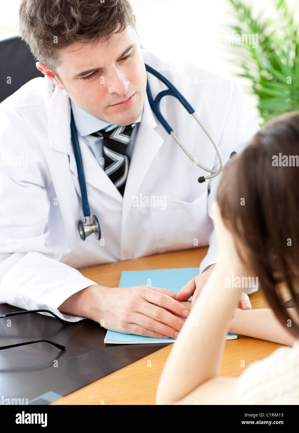 Self-assured surgeon with his upset patient Stock Photo - Alamy