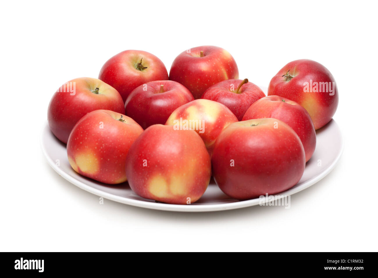 Red apple on plate on white background Stock Photo - Alamy