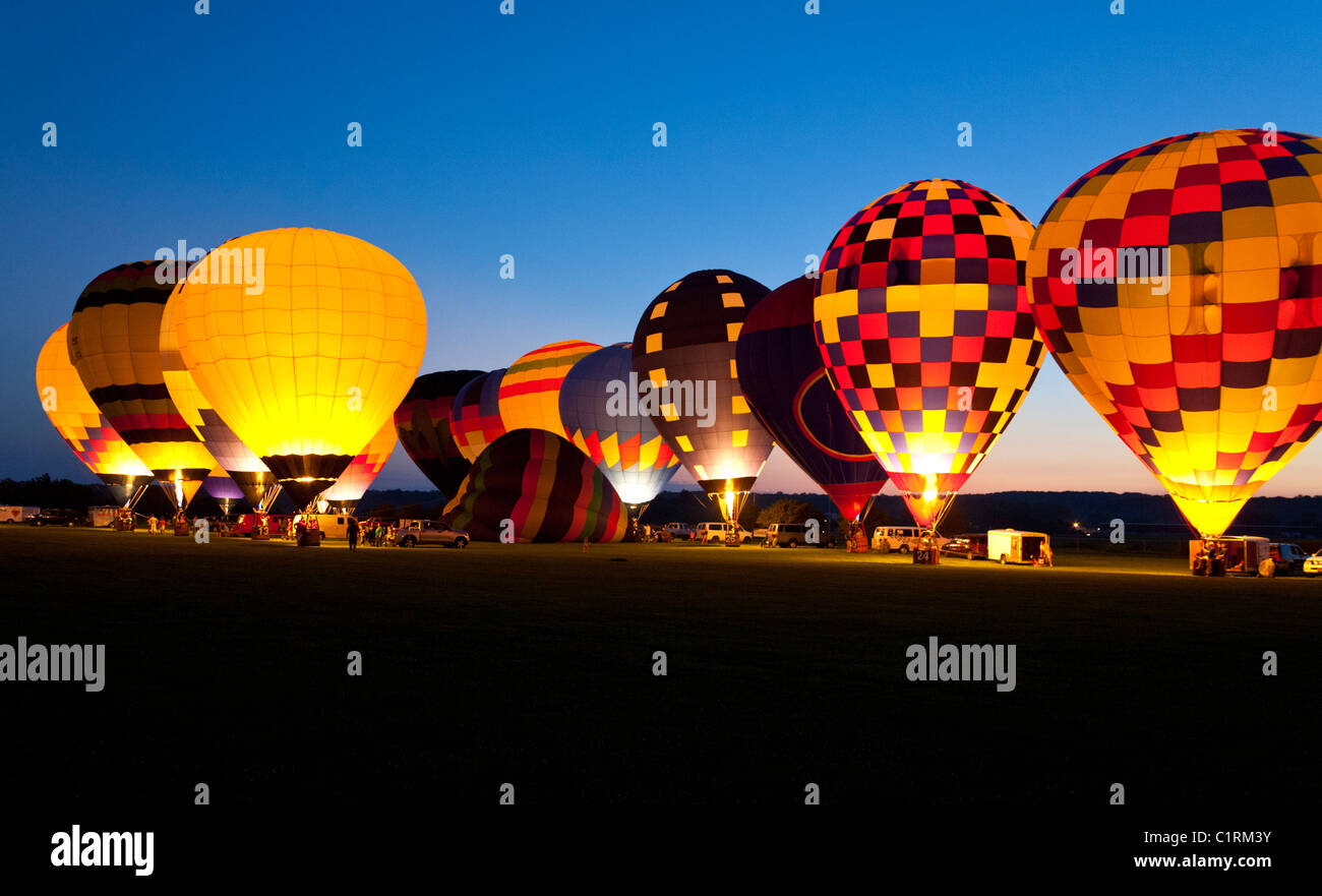 Hot air balloons illuminated at dusk Stock Photo - Alamy