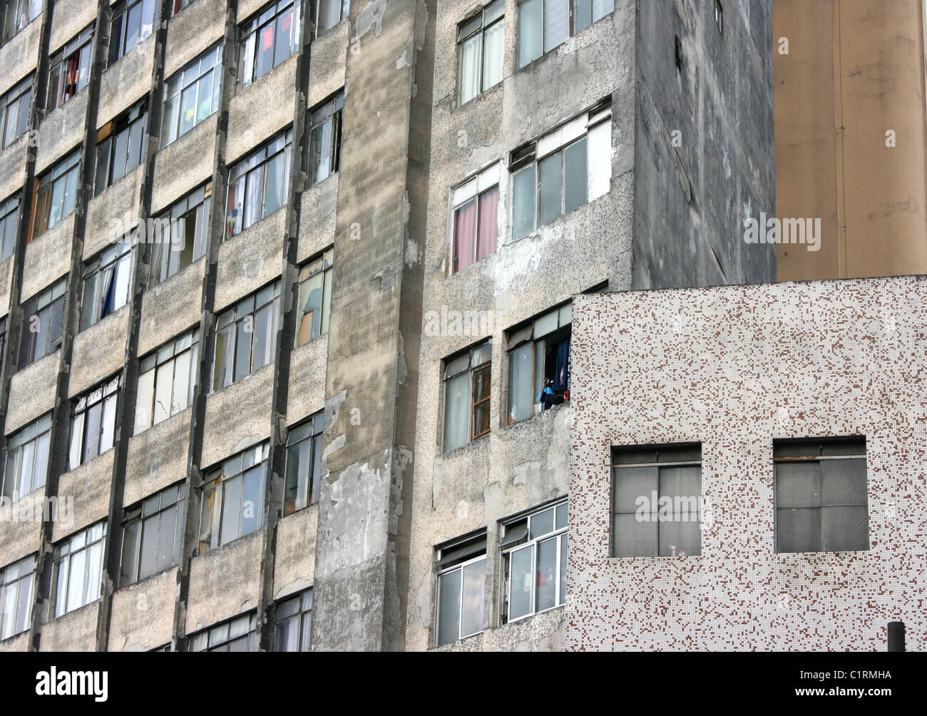 Facade of a rundown building in a poor neighborhood in the center of ...