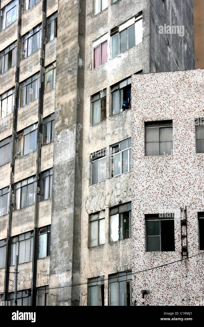 Facade of a rundown building in a poor neighborhood in the center of ...