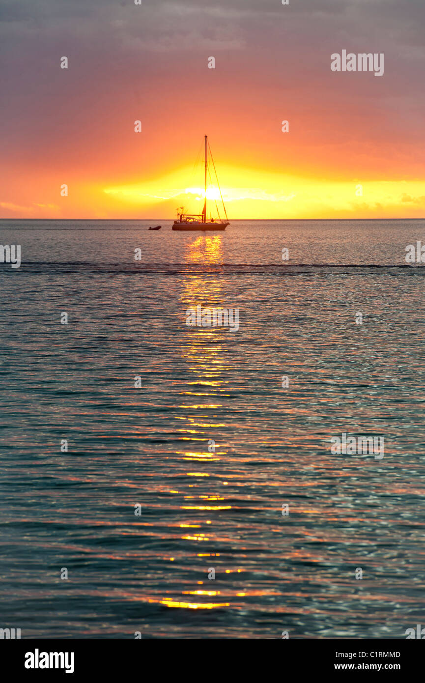 sailboat sailing into sunset Stock Photo - Alamy