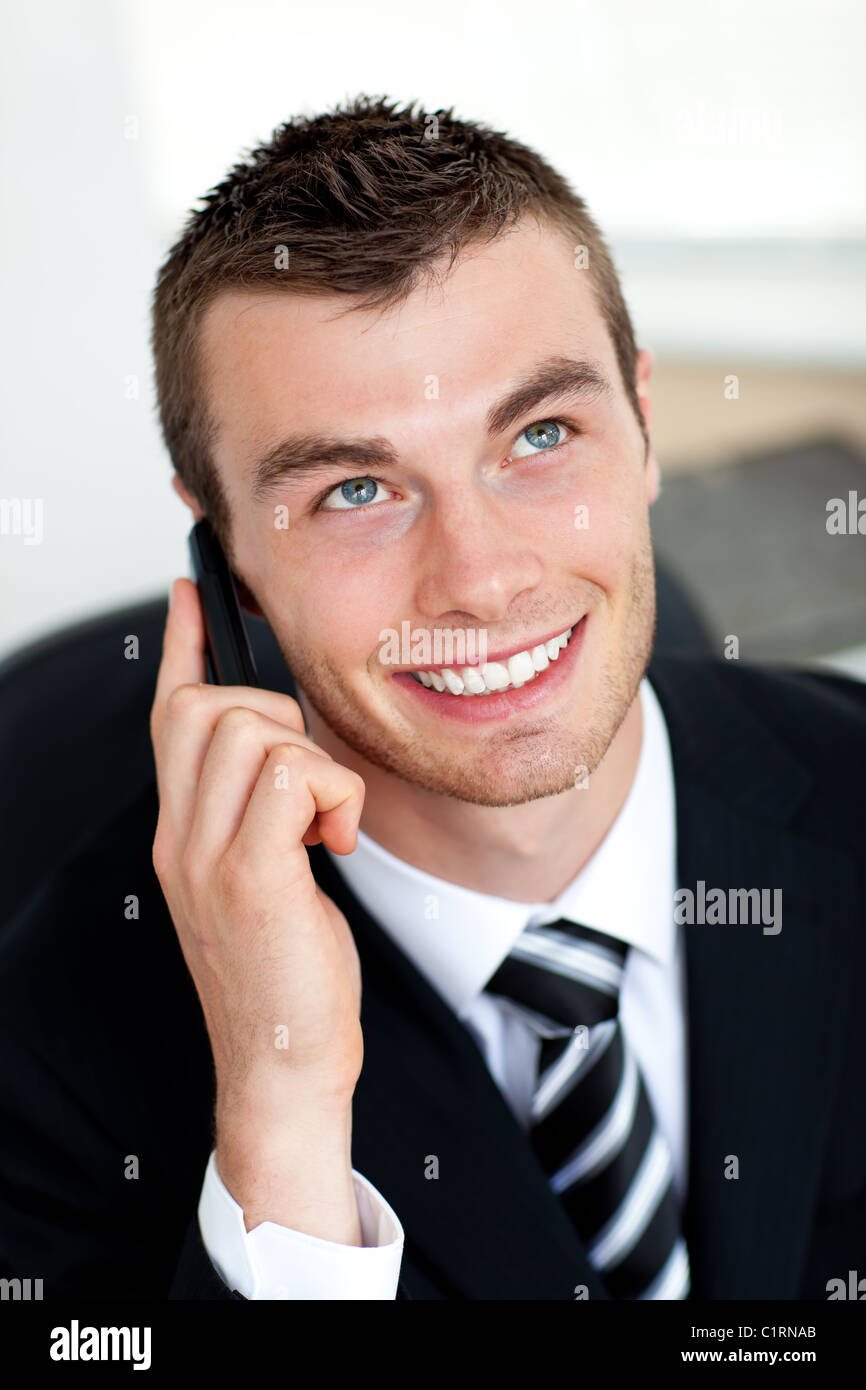 Simper businessman using mobile phone Stock Photo - Alamy