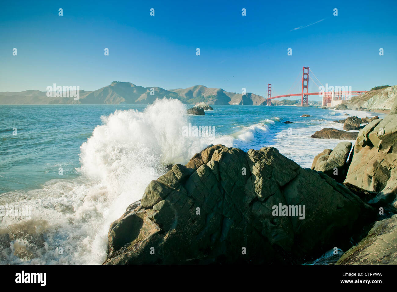 A large ocean wave crashing into rock at Baker Beach, Golden Gate ...