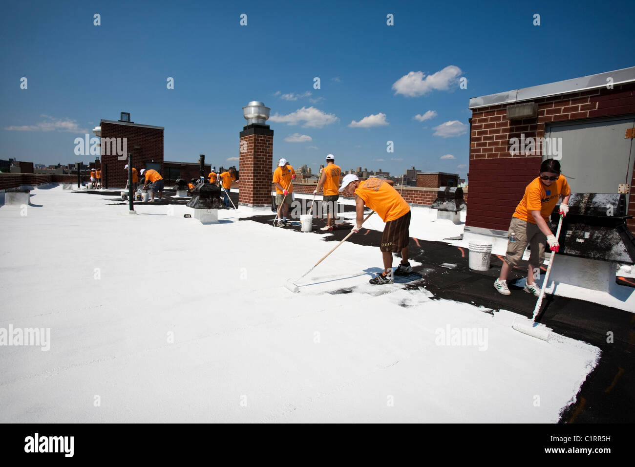 Volunteers paint Bronx, NY rooftop with specialized coating material ...