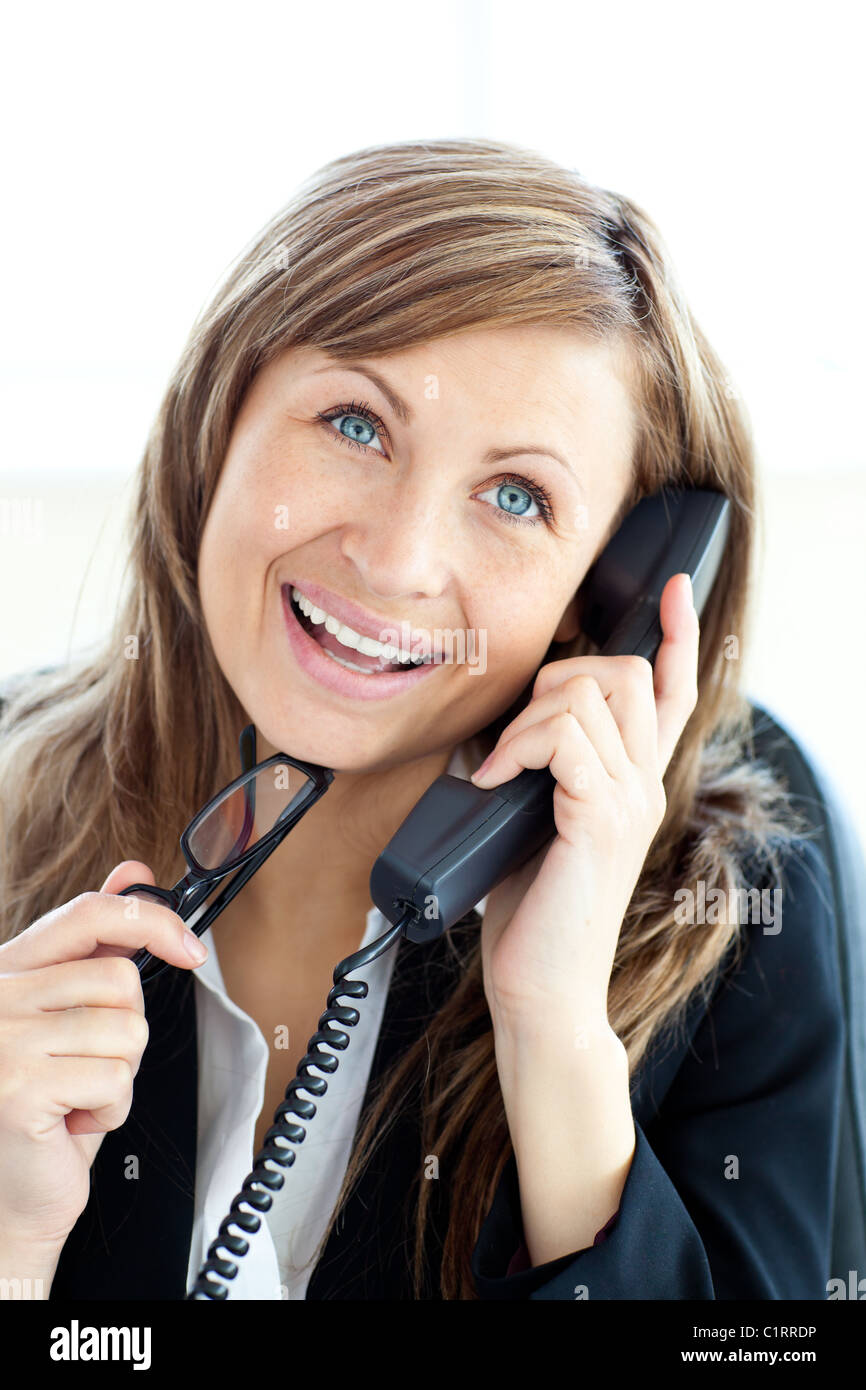 Confident young businesswoman talking on phone sitting Stock Photo - Alamy