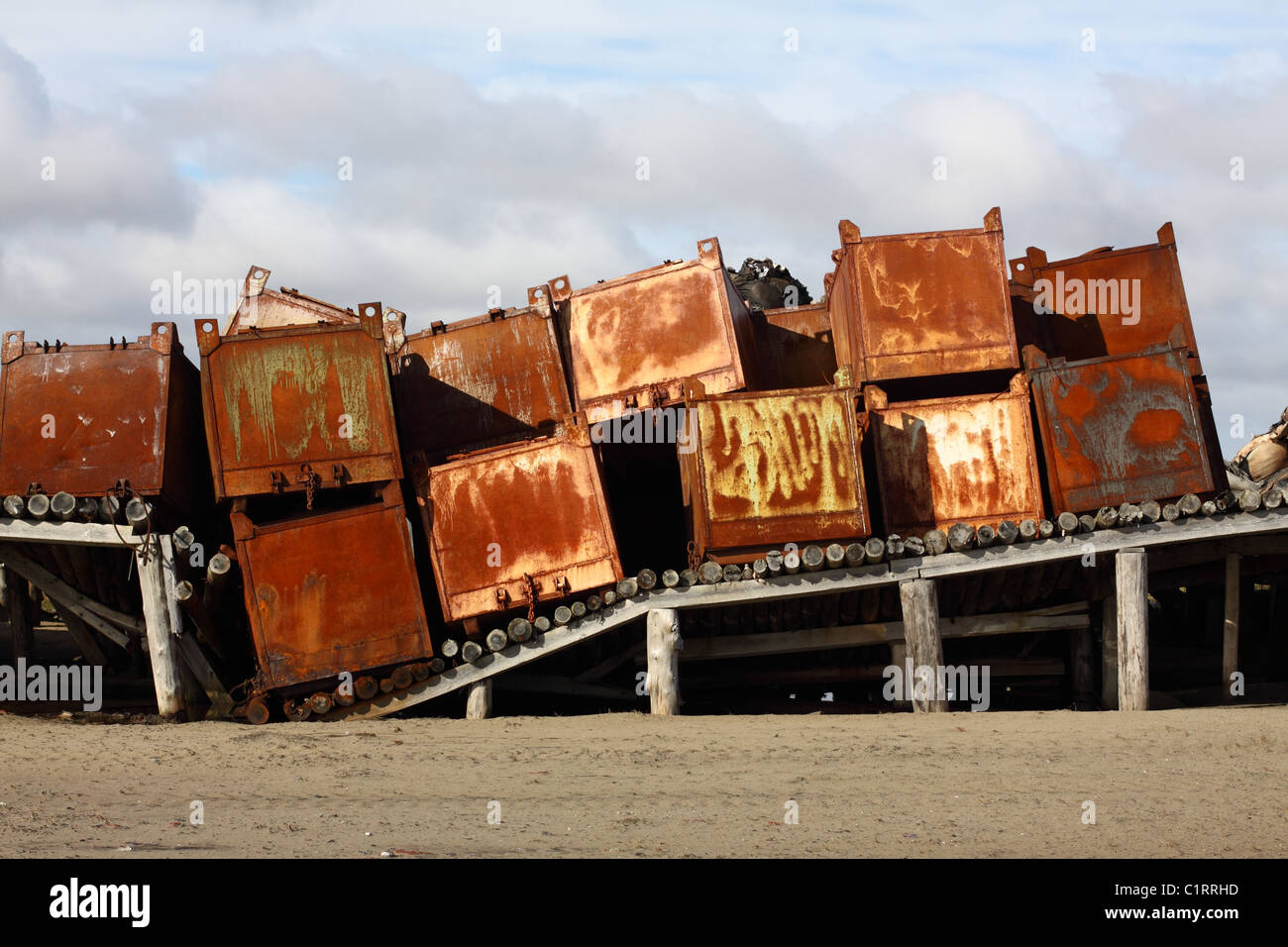 Iron containers on the broken wooden platform Stock Photo - Alamy