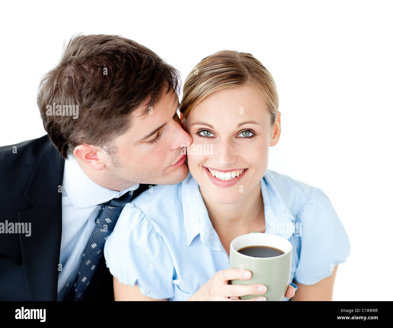 Attentive businessman kissing his girlfriend at her cheek Stock Photo ...