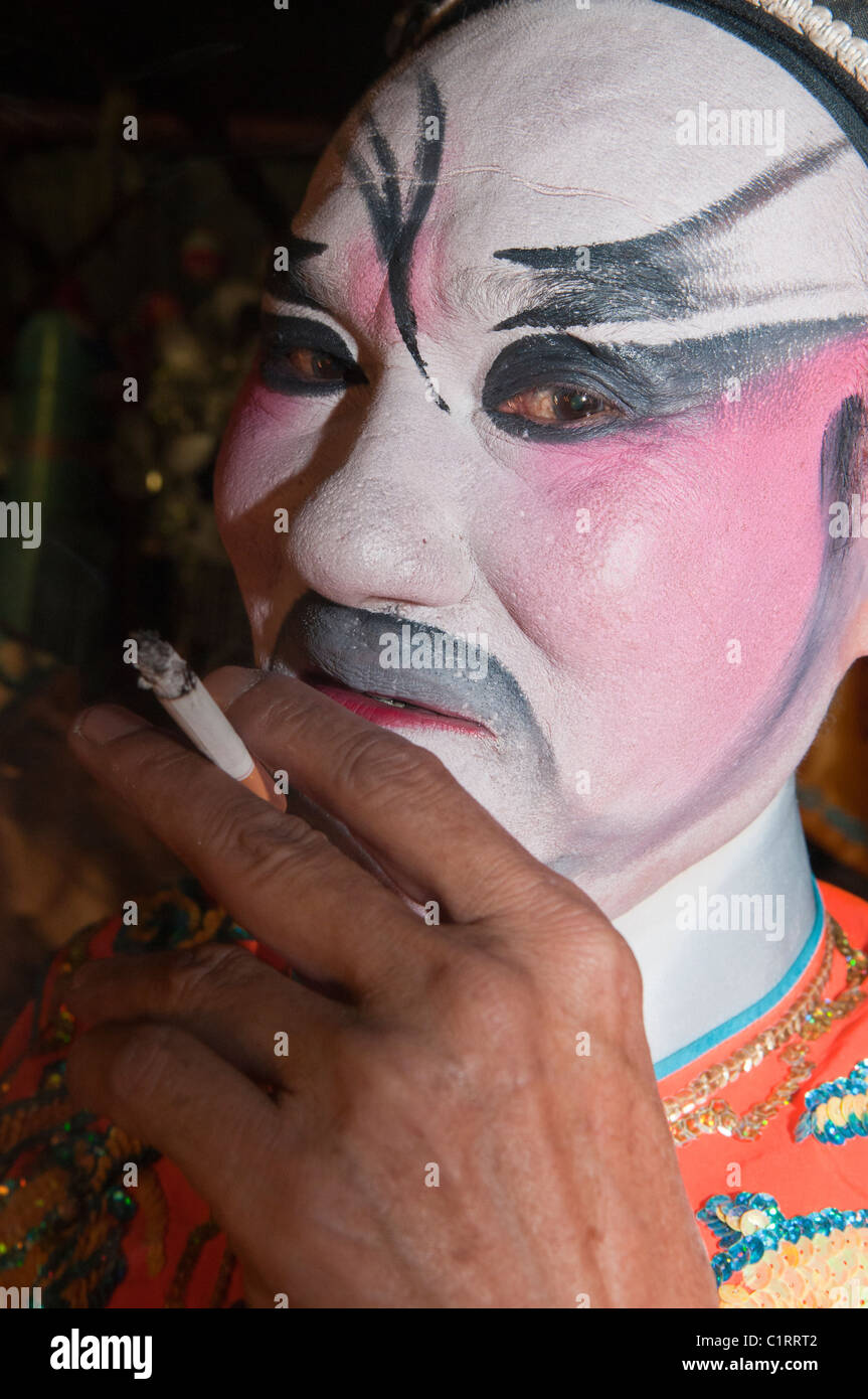 Chinese opera performer smoking backstage in Bangkok, Thailand Stock ...