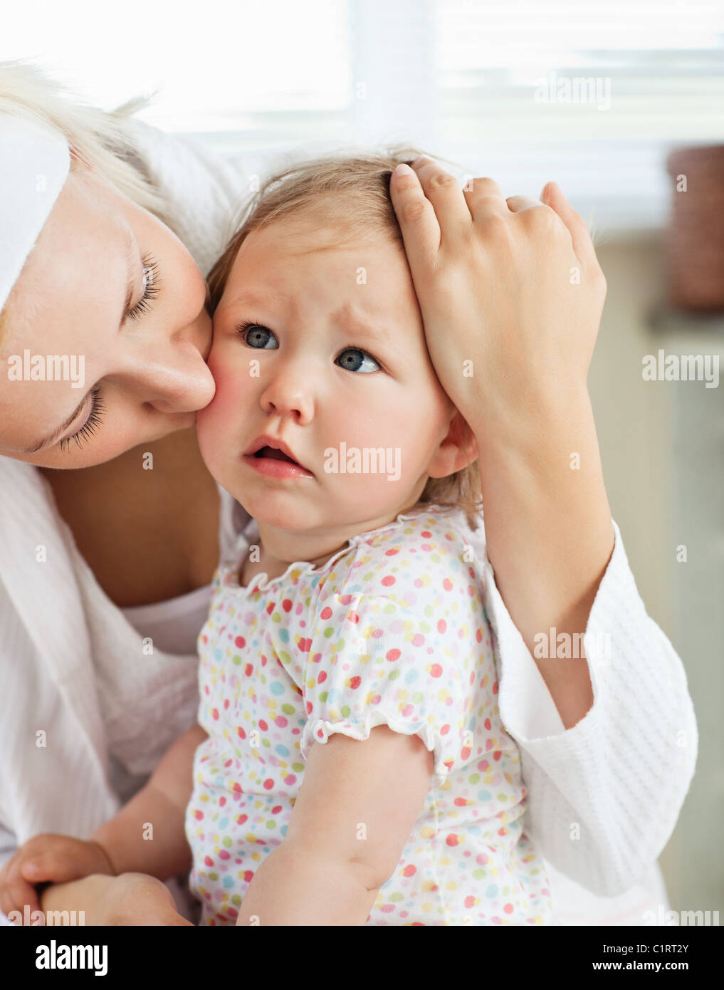 Mother taking care of her female child Stock Photo - Alamy