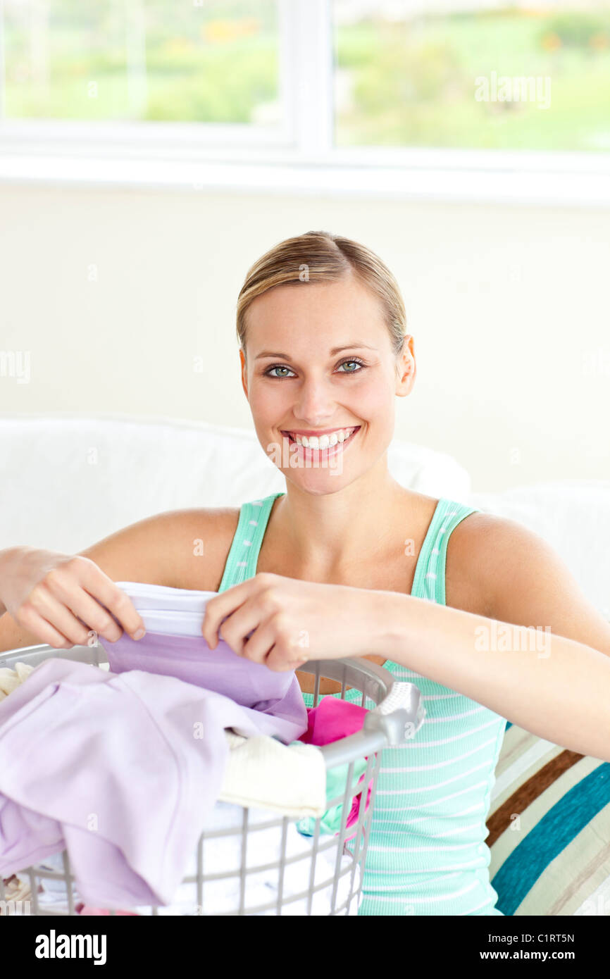 Cheerful young woman doing the laundry Stock Photo - Alamy