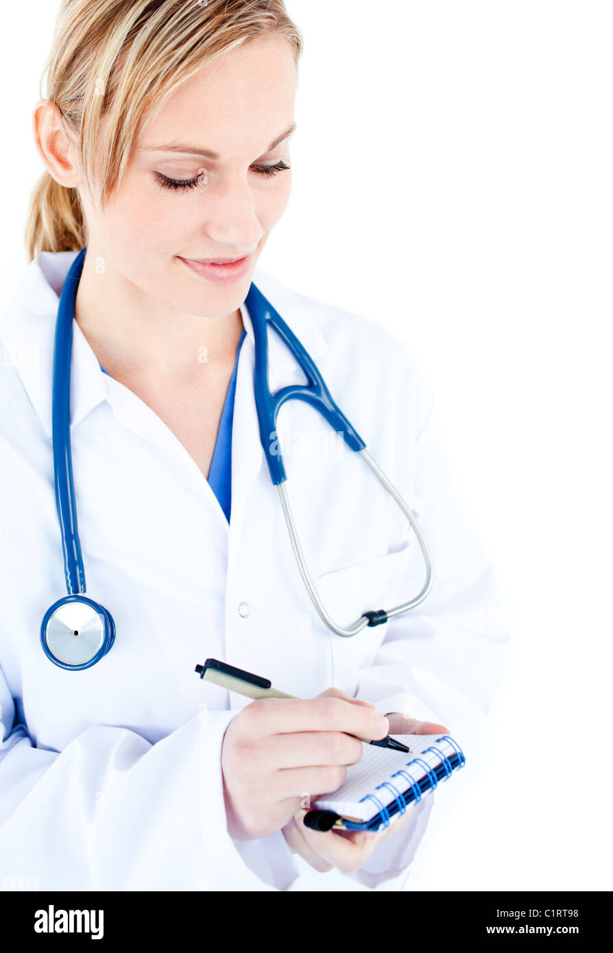 Concentrated female doctor taking notes on her notepad Stock Photo - Alamy