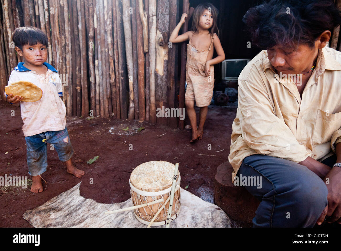 Mbya Guarani craftsman demonstrating a traditional flute (mimby puku ...