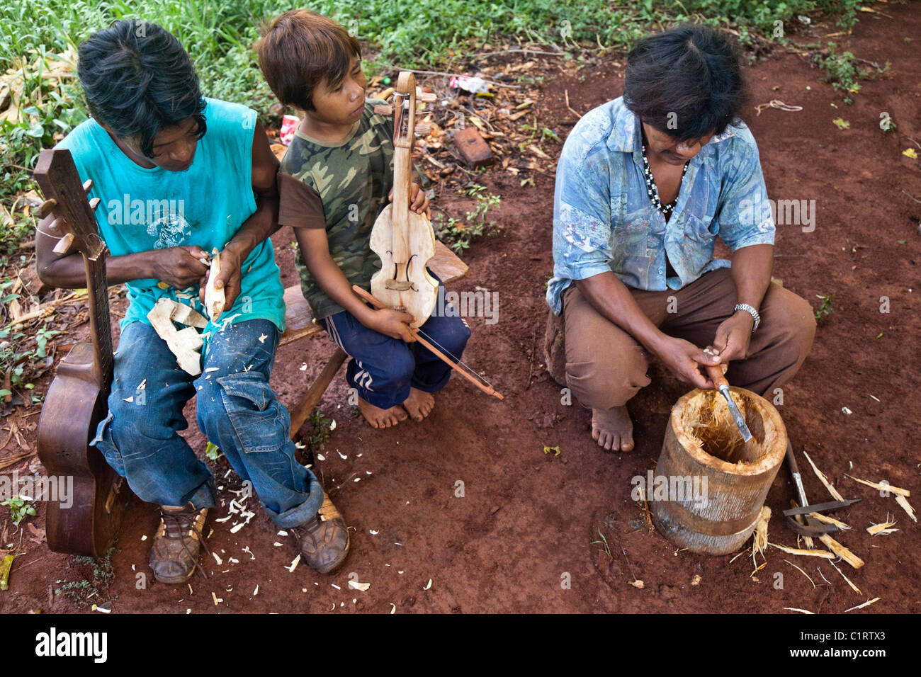 Mbya Guarani craftsman hand-building a Guarani drum (anguapu) from a ...