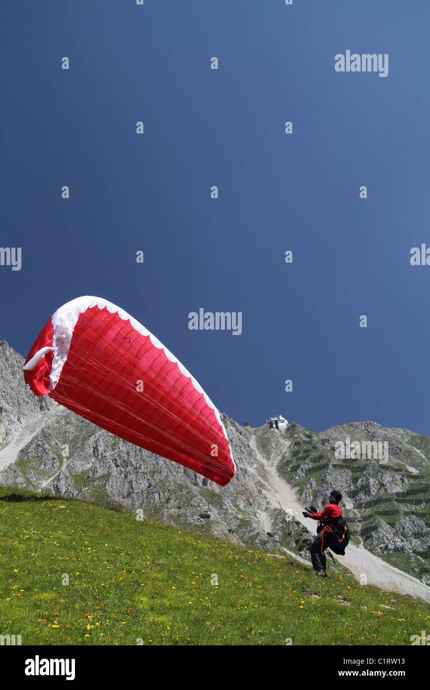 Paraglider taking off at the Nordkette mountain range, Innsbruck Stock ...