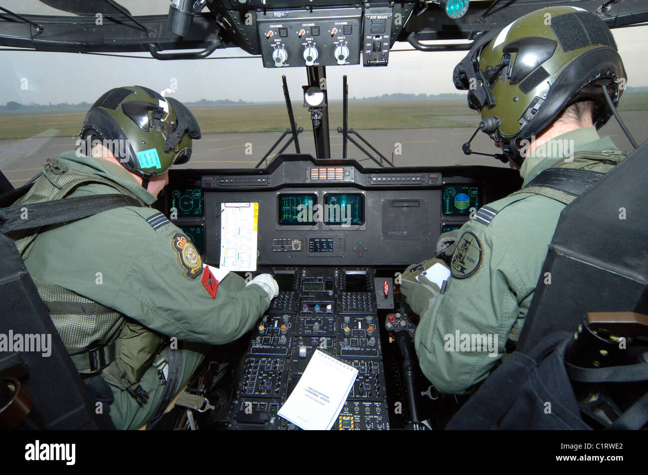 Pilots inside the cockpit of a Royal Air Force Merlin Helicopter at RAF ...