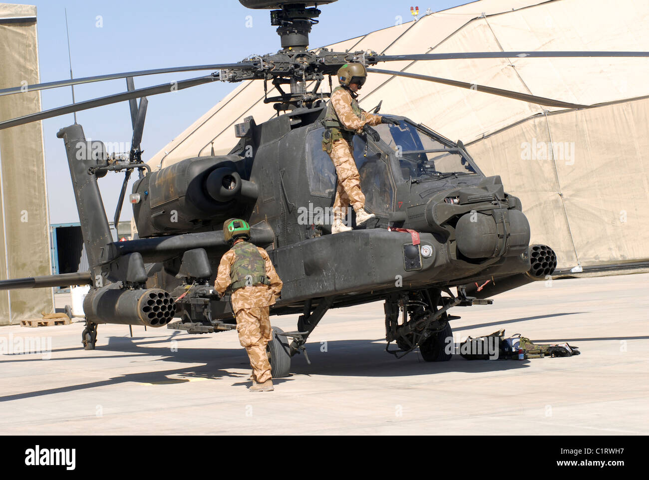 British soldiers perform maintenance on an Apache helicopter at Camp ...