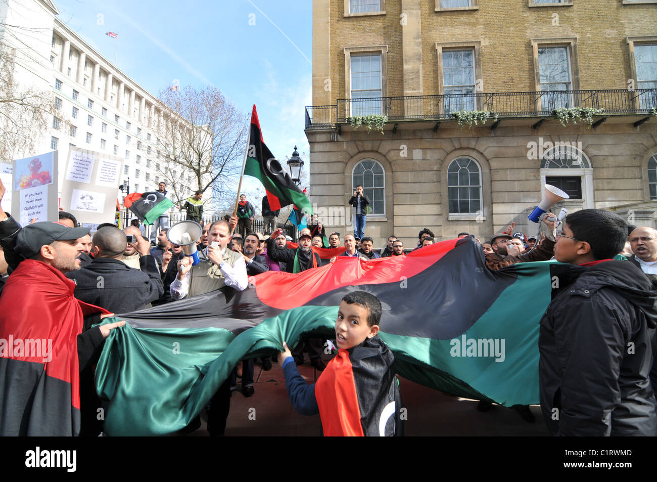 Libyan anti Gaddafi protest outside Downing Street waving flags ...