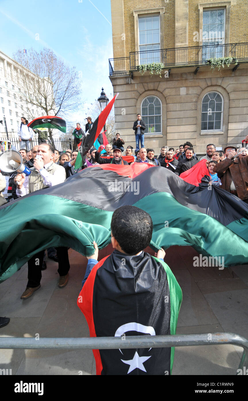Libyan anti Gaddafi protest outside Downing Street waving flags ...