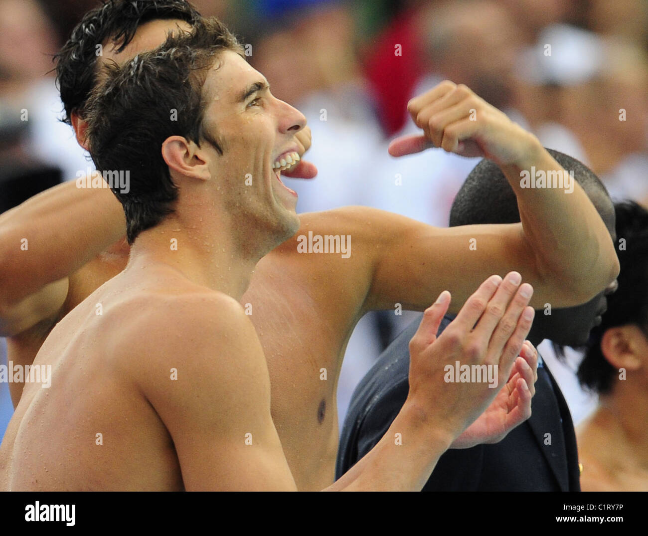 Michael Phelps of the U.S. cheers for a teammate during the Men's ...