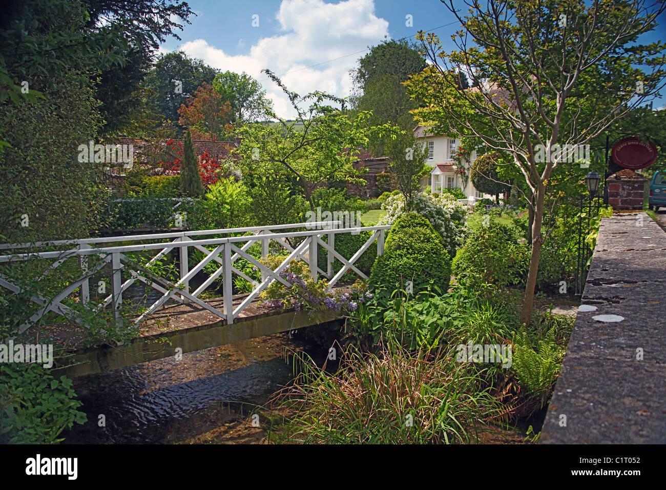 The River Cerne flowing through the garden of a house in Cerne Abbas ...