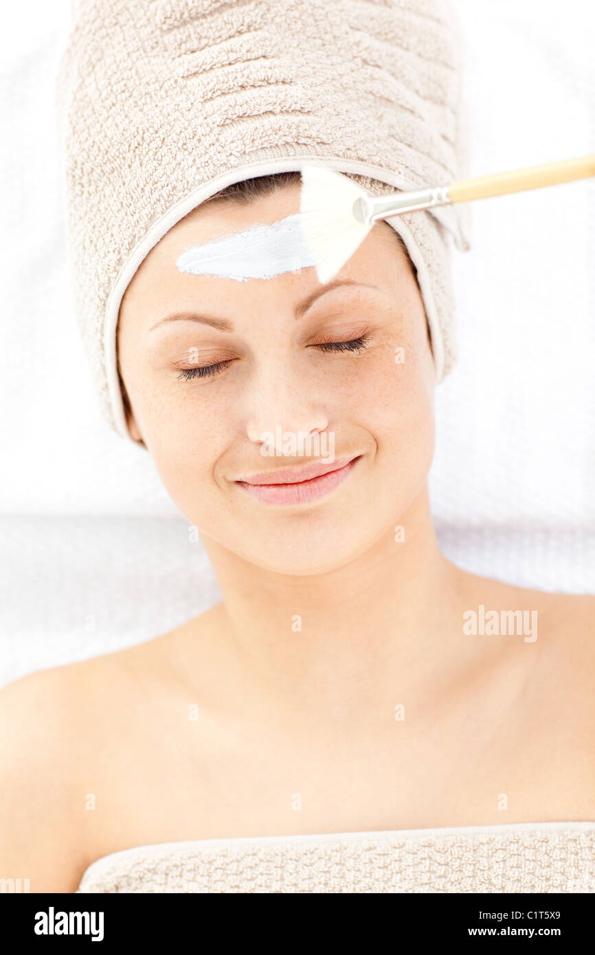 Happy relaxed woman receiving white cream on her face Stock Photo - Alamy