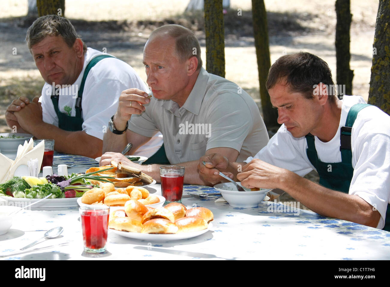 Prime Minister Vladimir Putin (c) having dinner in the field with the ...