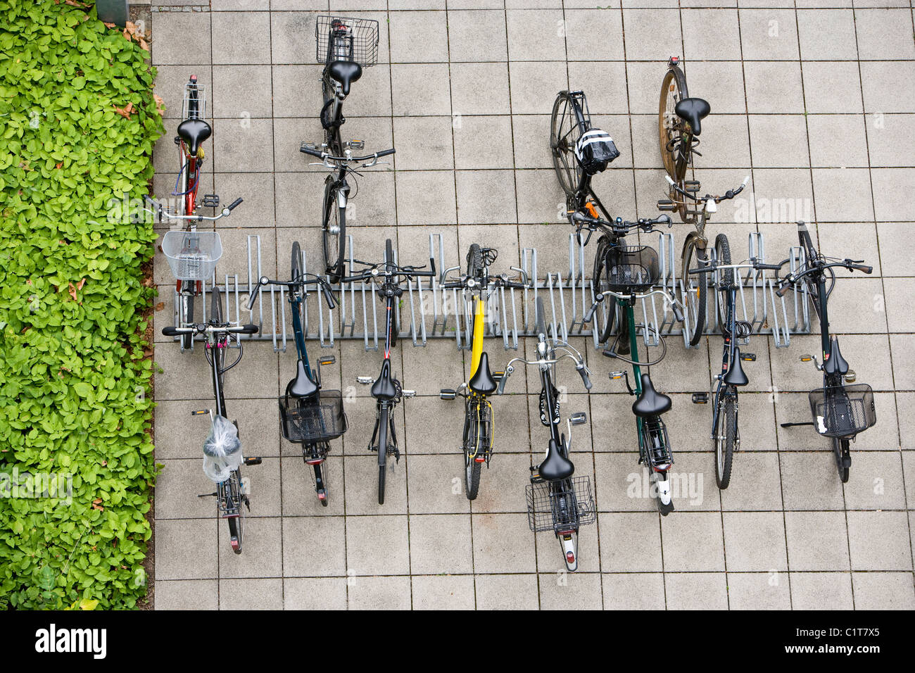 Bicycles parked in bicycle rack, overhead view Stock Photo - Alamy