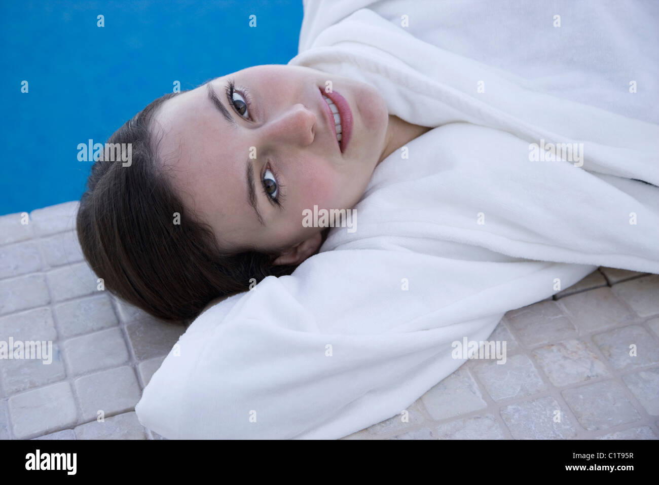 Woman relaxing beside pool, portrait Stock Photo - Alamy