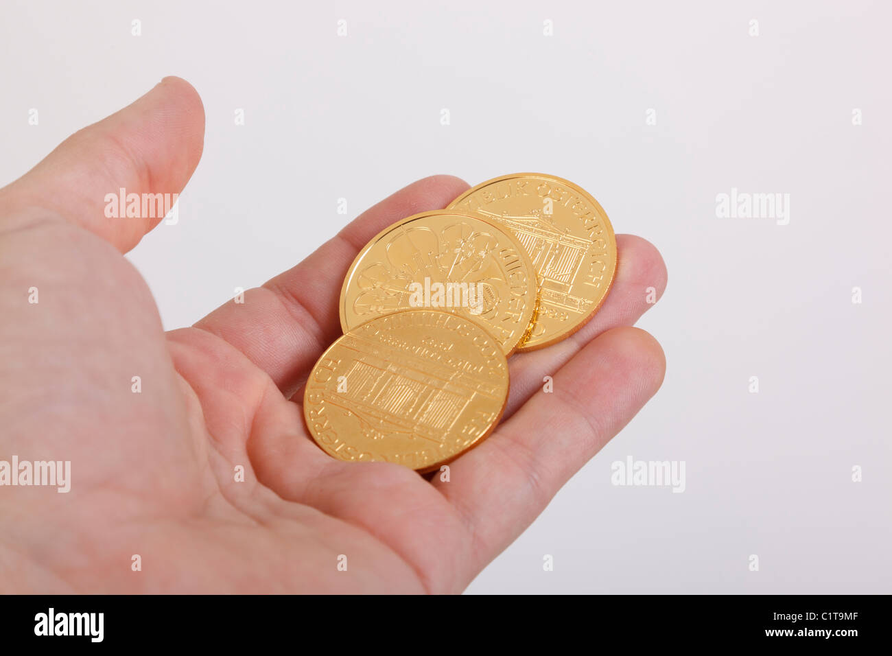 gold coins in hand Stock Photo - Alamy