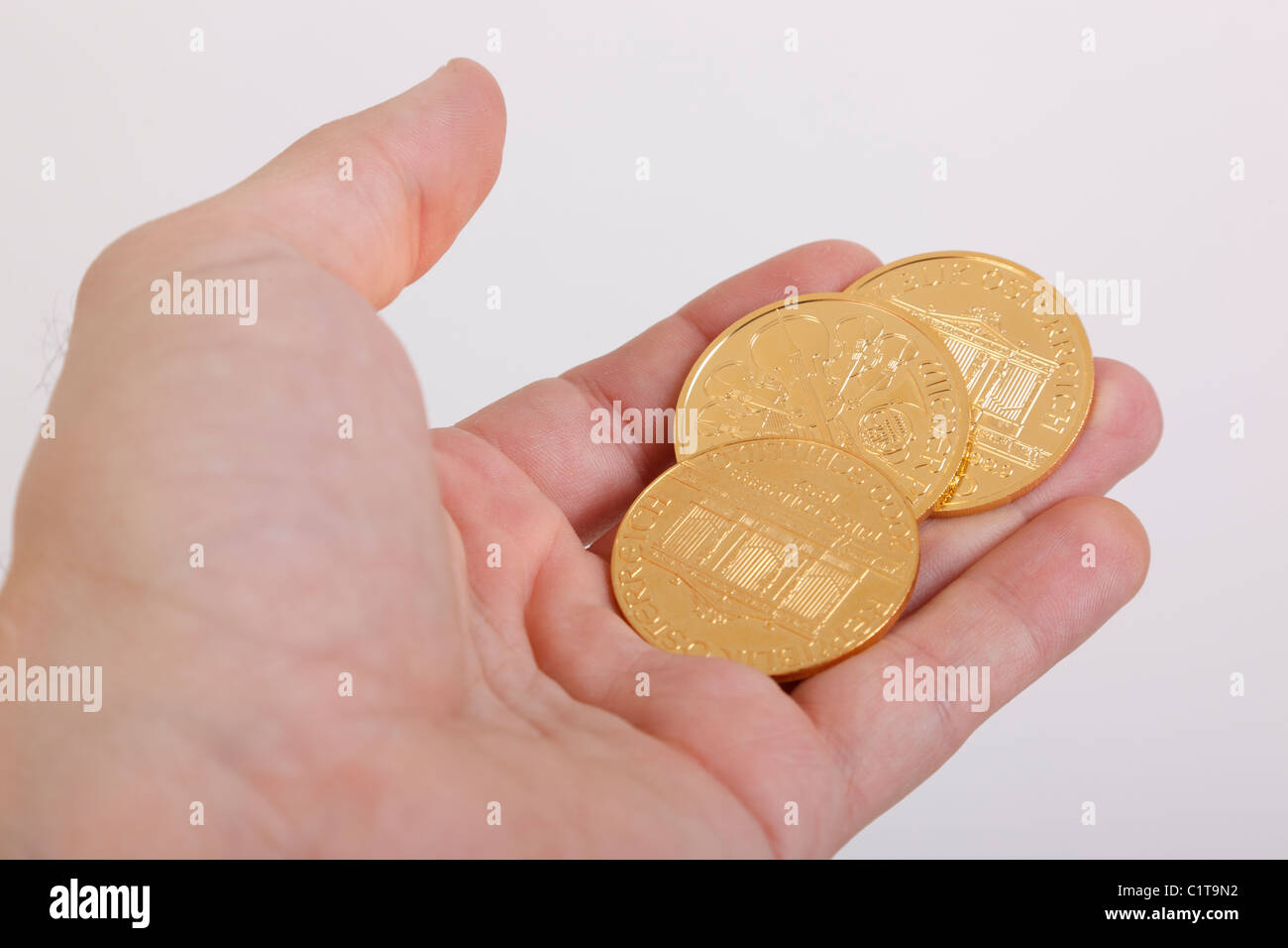 gold coins in hand Stock Photo - Alamy