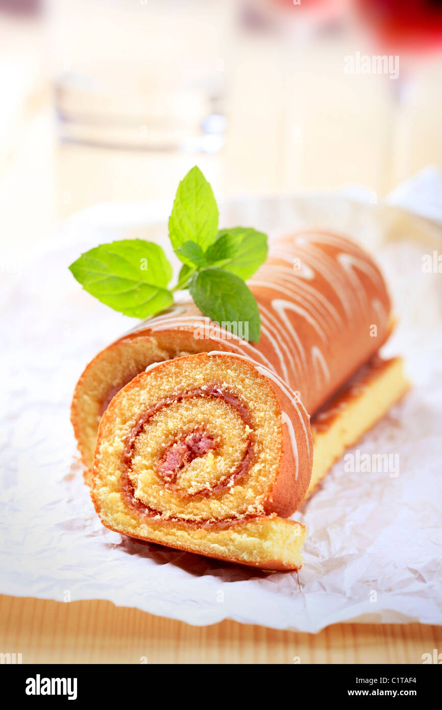 Swiss roll, slice cut off - front view Stock Photo - Alamy