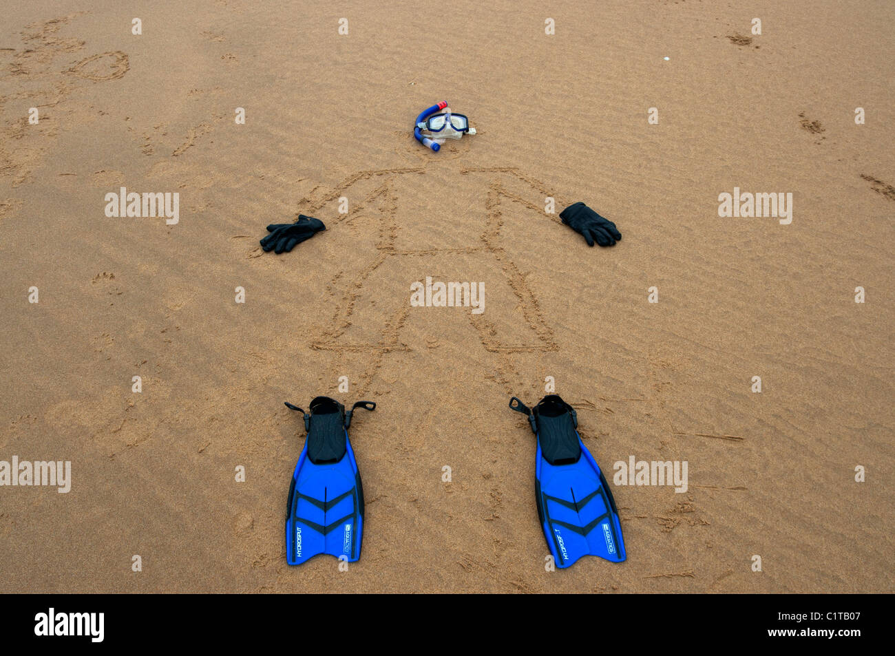 Man drawn in sand with flippers mask and snorkel beach art Stock Photo ...